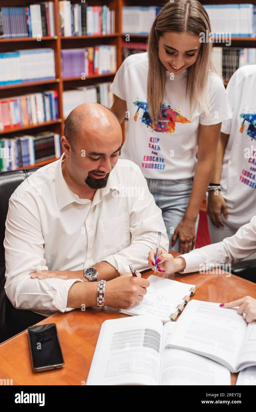 Students helping each other in class hi-res stock photography and ...