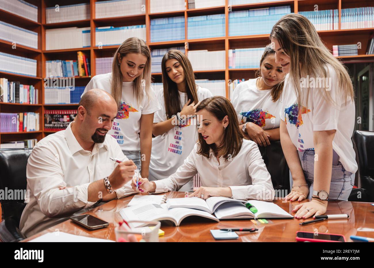 Students helping each other in class hi-res stock photography and ...