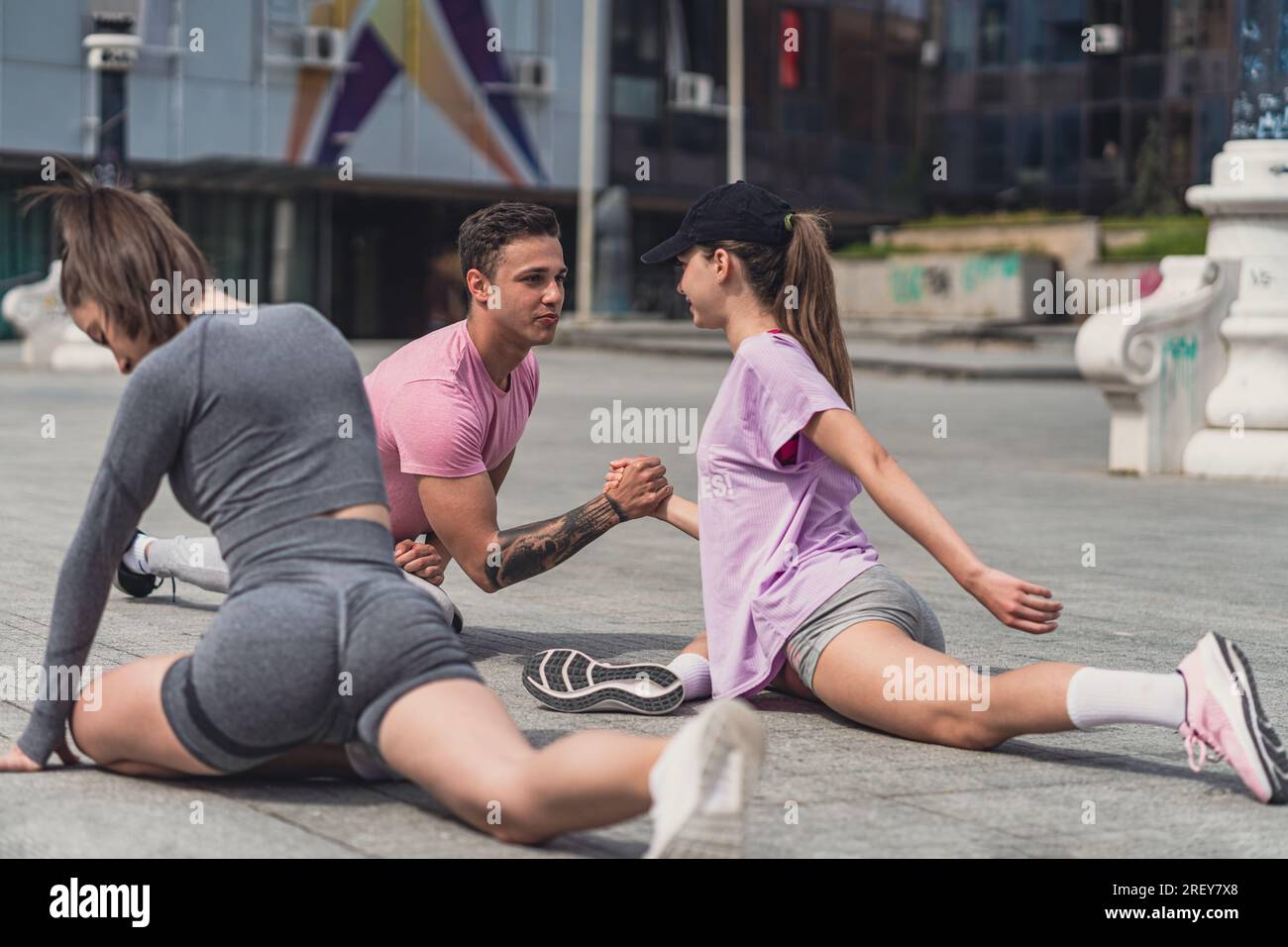 A shot of sensual friends stretching their bodies. They are holding ...