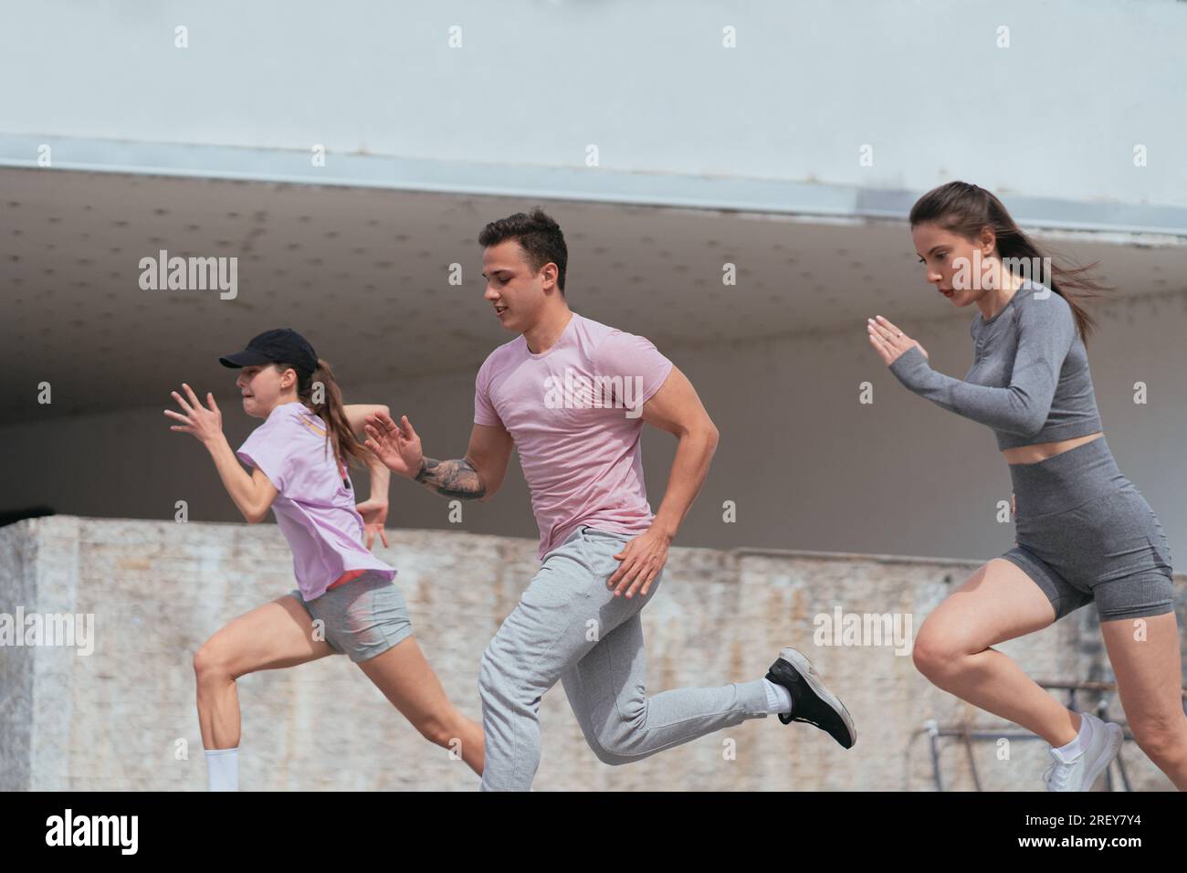 Fit sportspeople sprinting. Side view shot Stock Photo - Alamy