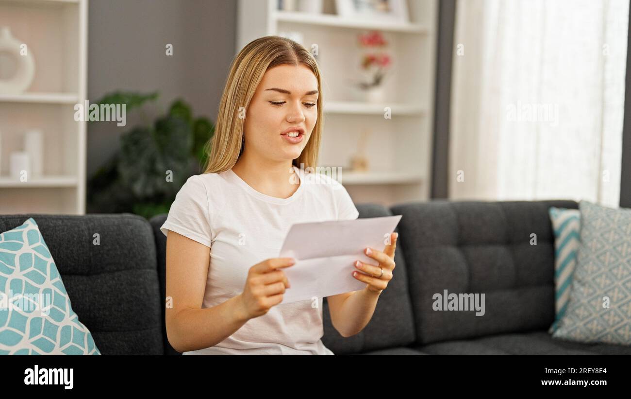 Woman letter read sofa hi-res stock photography and images - Alamy