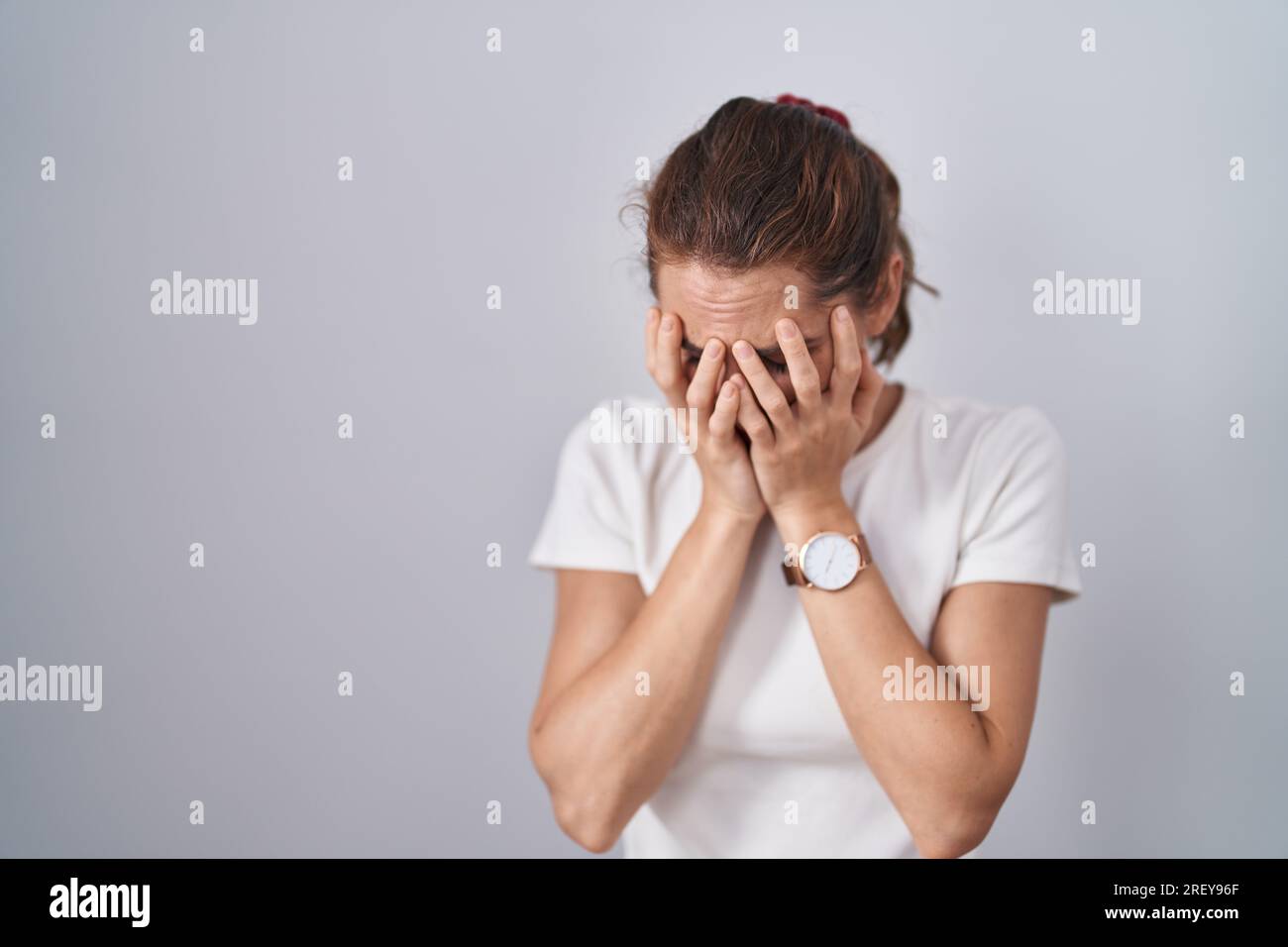 Beautiful brunette woman standing over isolated background with sad ...