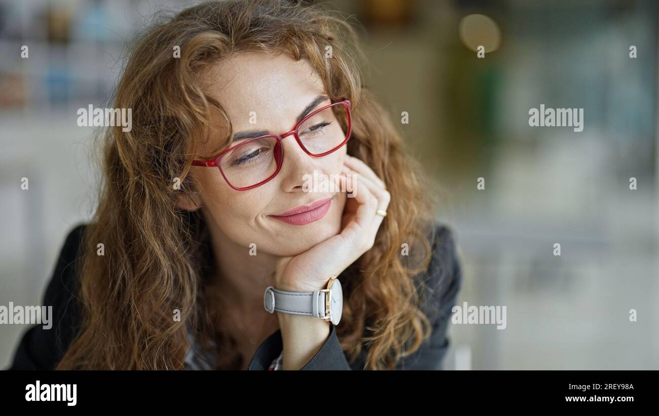 Young woman business worker sitting on table thinking at the office ...