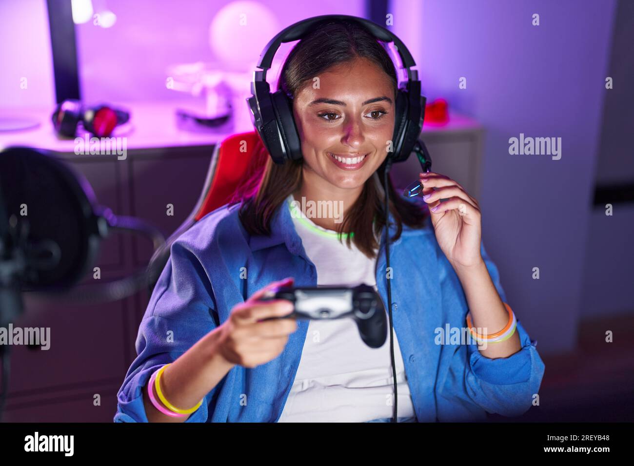 Young beautiful hispanic woman streamer playing video game using ...