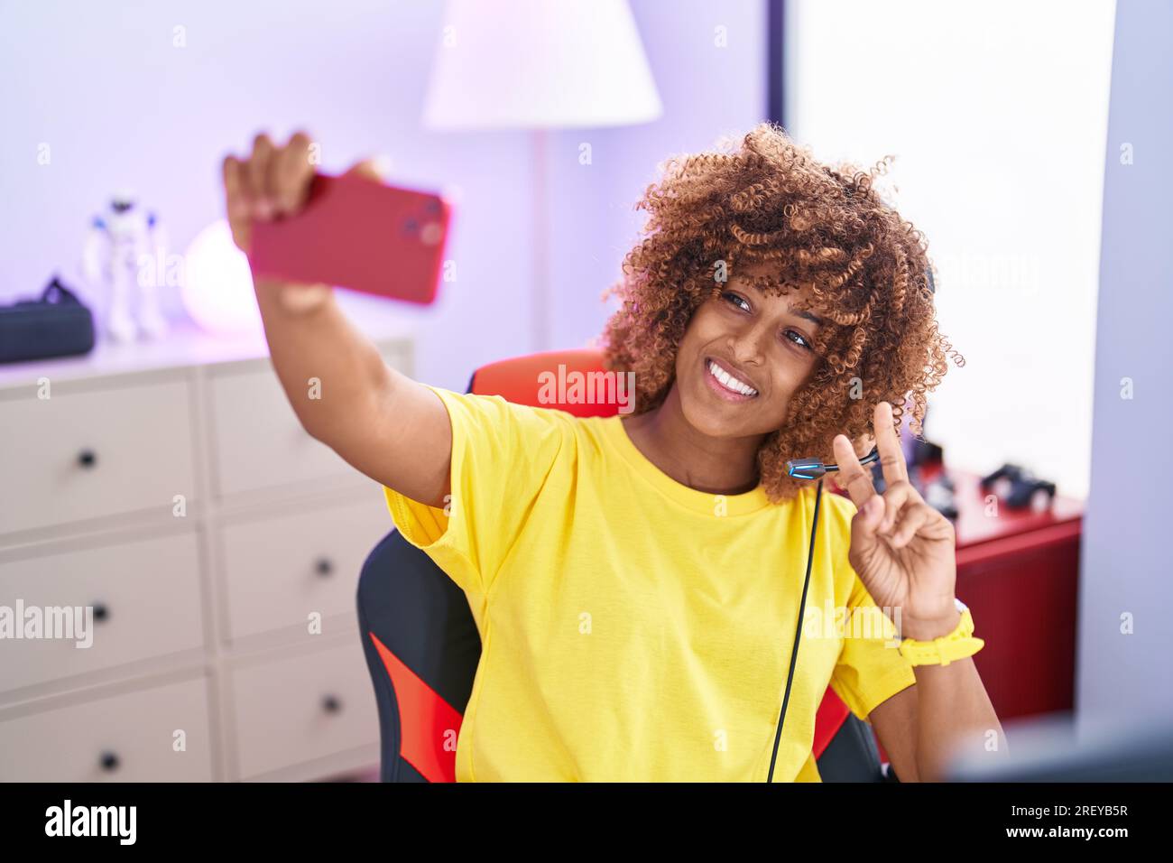 African american woman streamer make selfie by smartphone at gaming ...