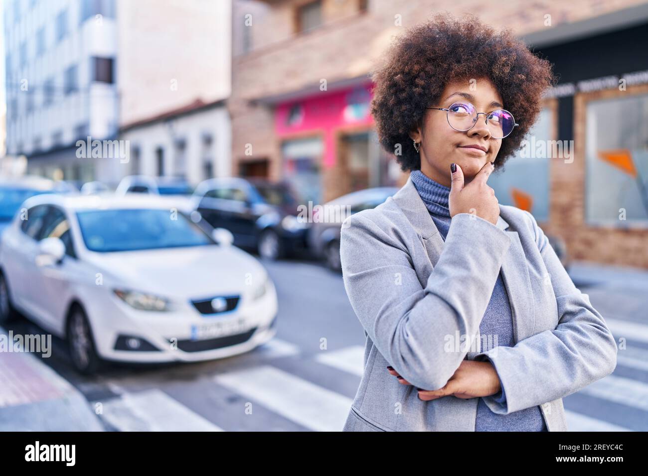 African american woman executive standing with doubt expression at ...