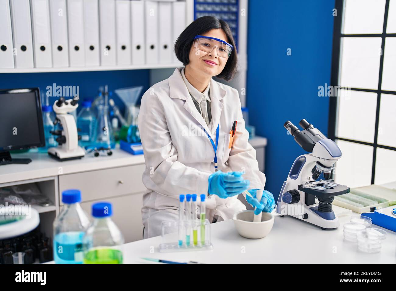 Young chinese woman scientist working at laboratory Stock Photo - Alamy