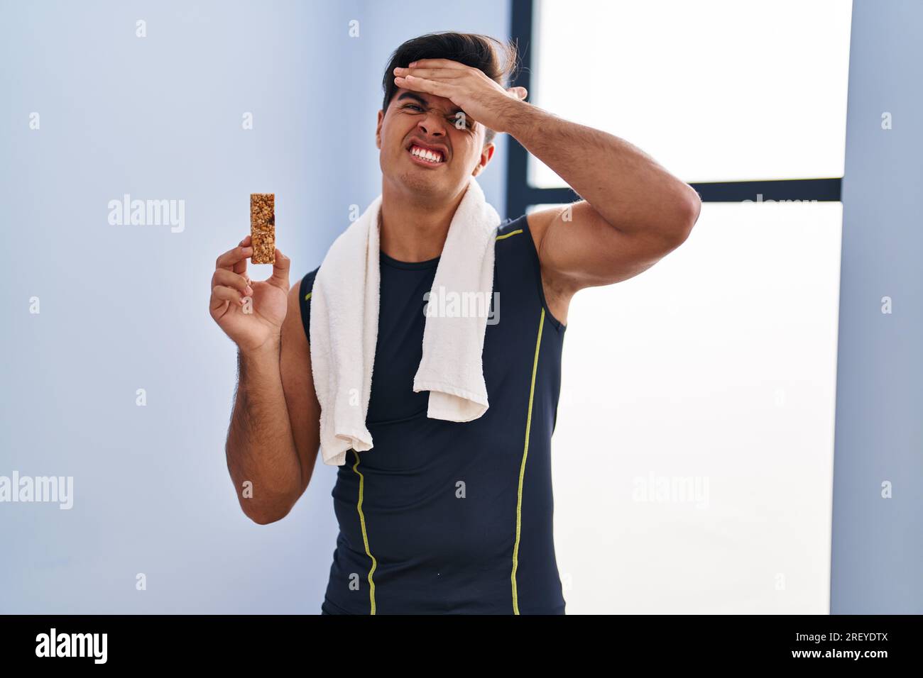 Hispanic man eating protein bar as healthy energy snack stressed and ...