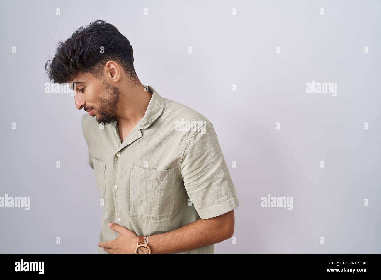 Arab man with beard standing over white background suffering of ...