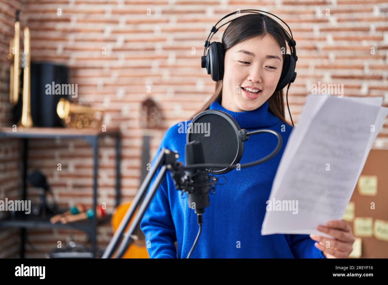Chinese woman artist singing song at music studio Stock Photo - Alamy