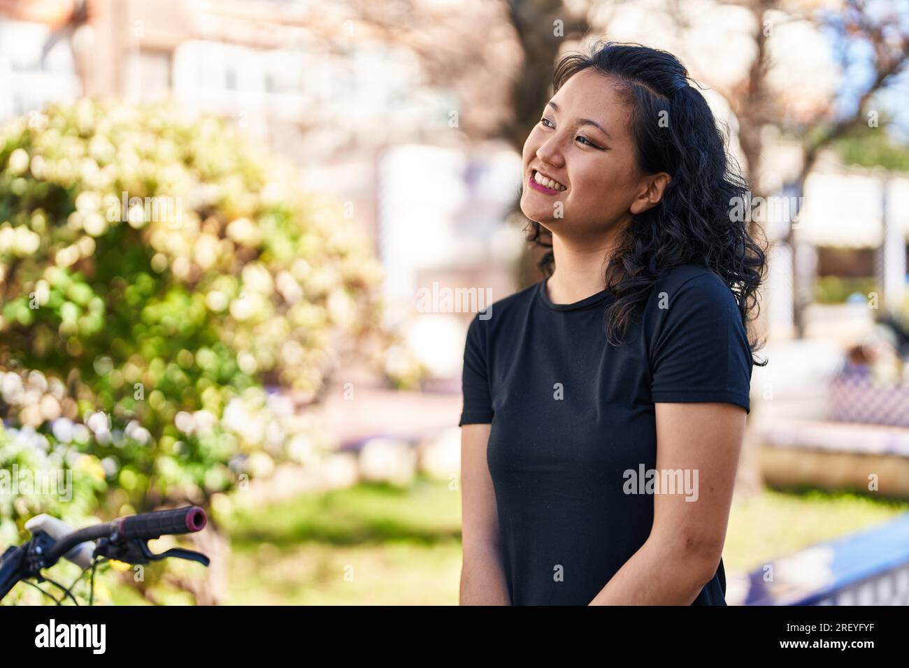Young chinese woman smiling confident standing at park Stock Photo - Alamy