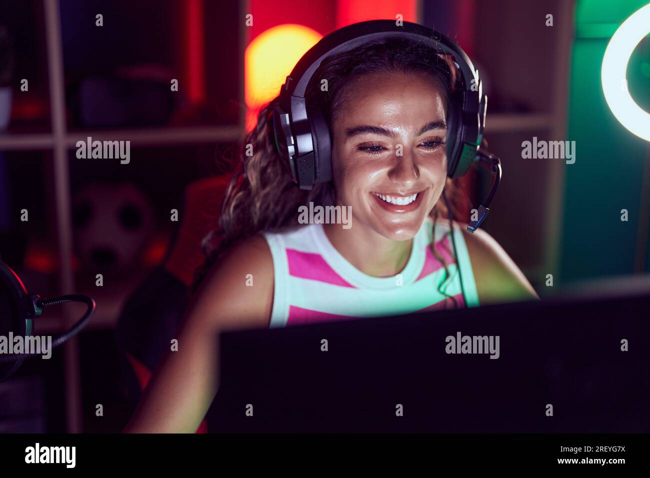 Young beautiful hispanic woman streamer playing video game using ...