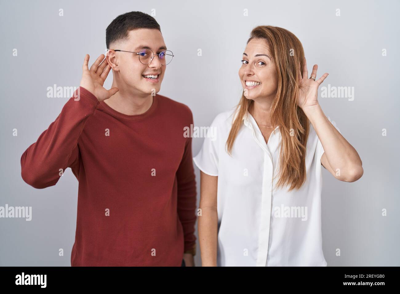 Mother and son standing together over isolated background smiling with ...