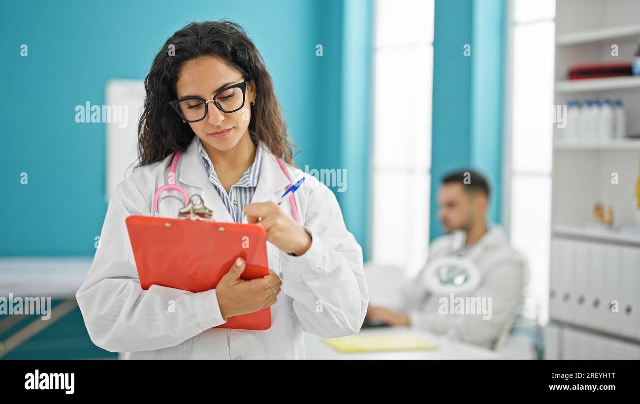 Man and woman doctors taking notes working at the clinic Stock Photo ...