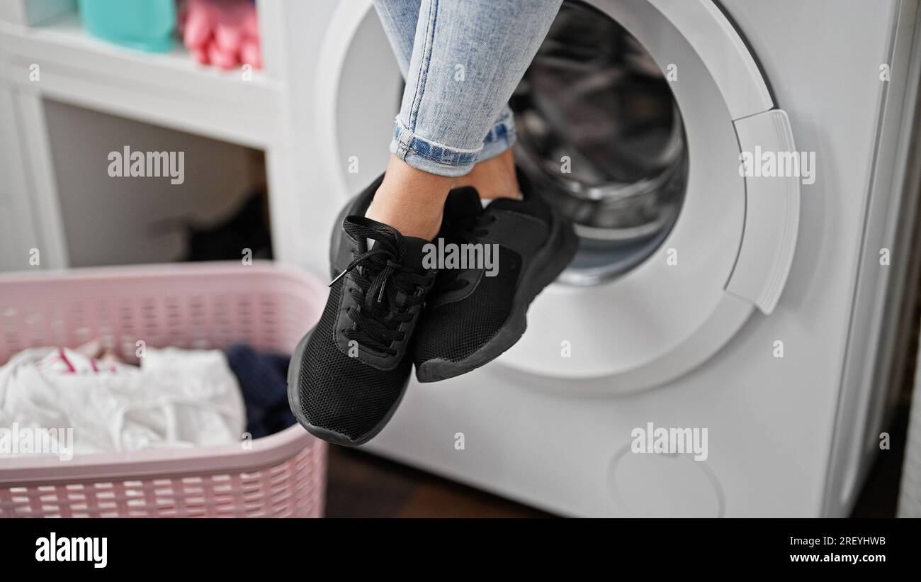 Woman sitting on washing machine hi-res stock photography and images ...