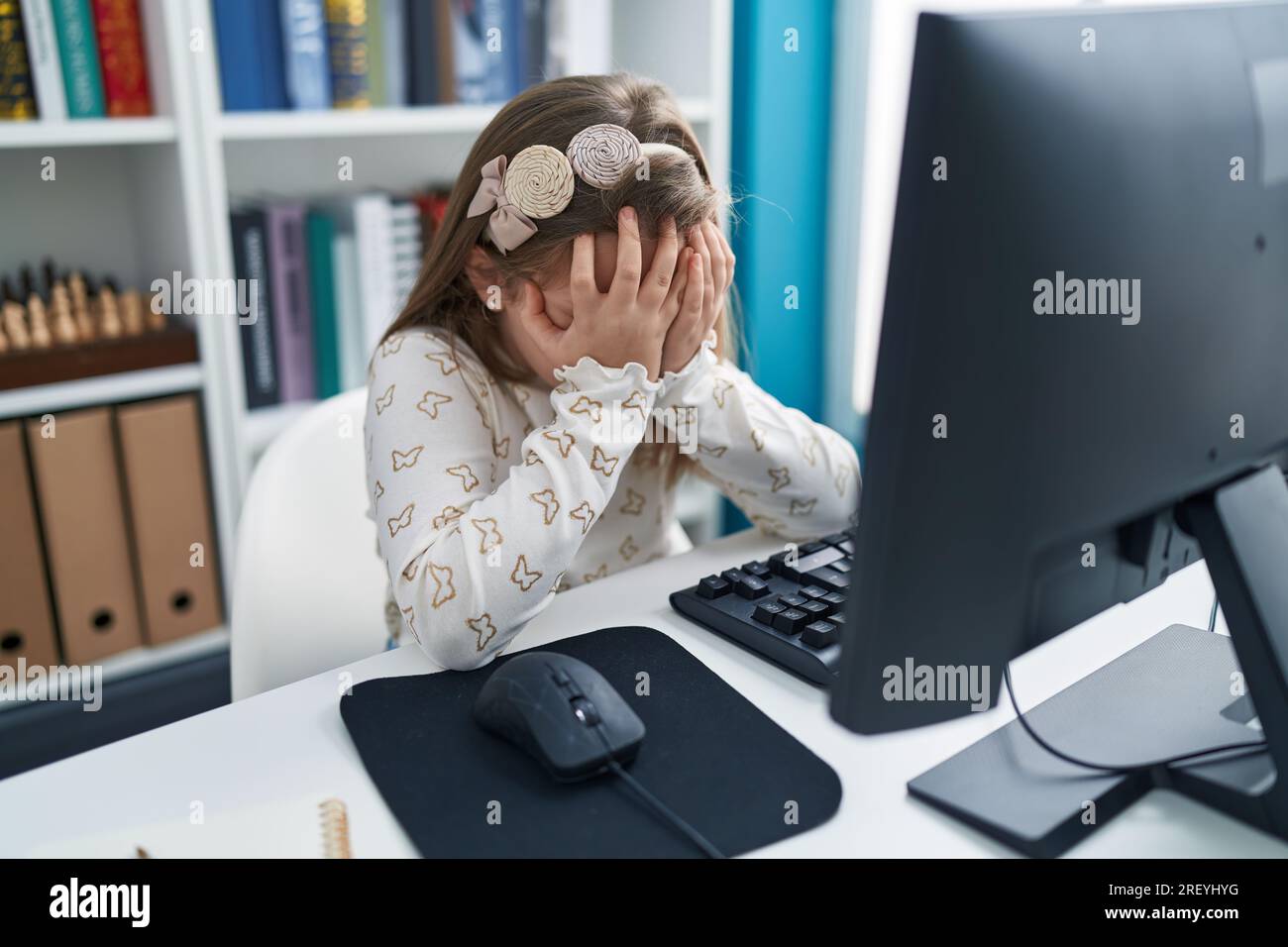 Adorable blonde girl student stressed using computer at classroom Stock ...