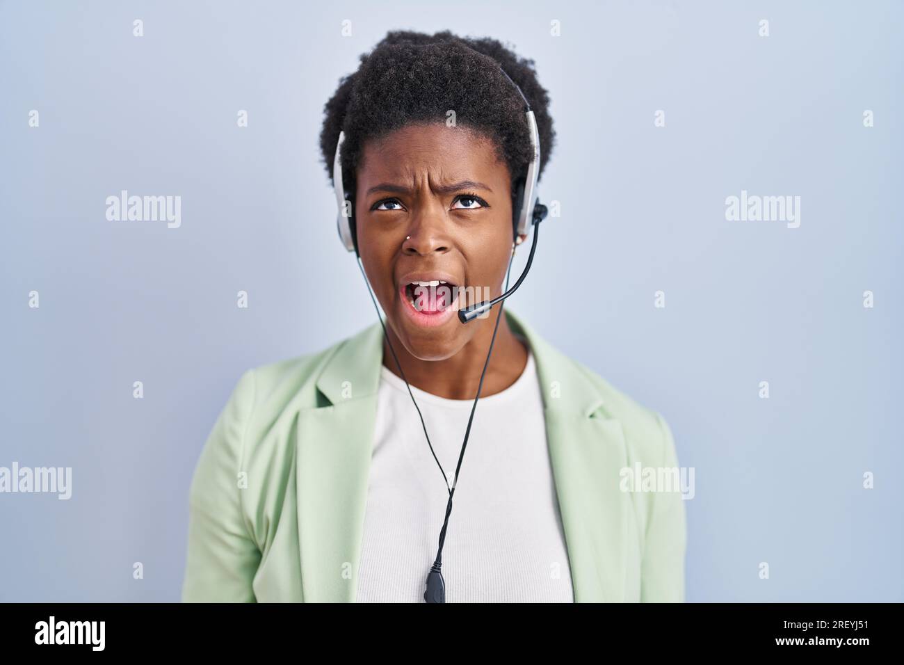 African american woman wearing call center agent headset angry and mad ...