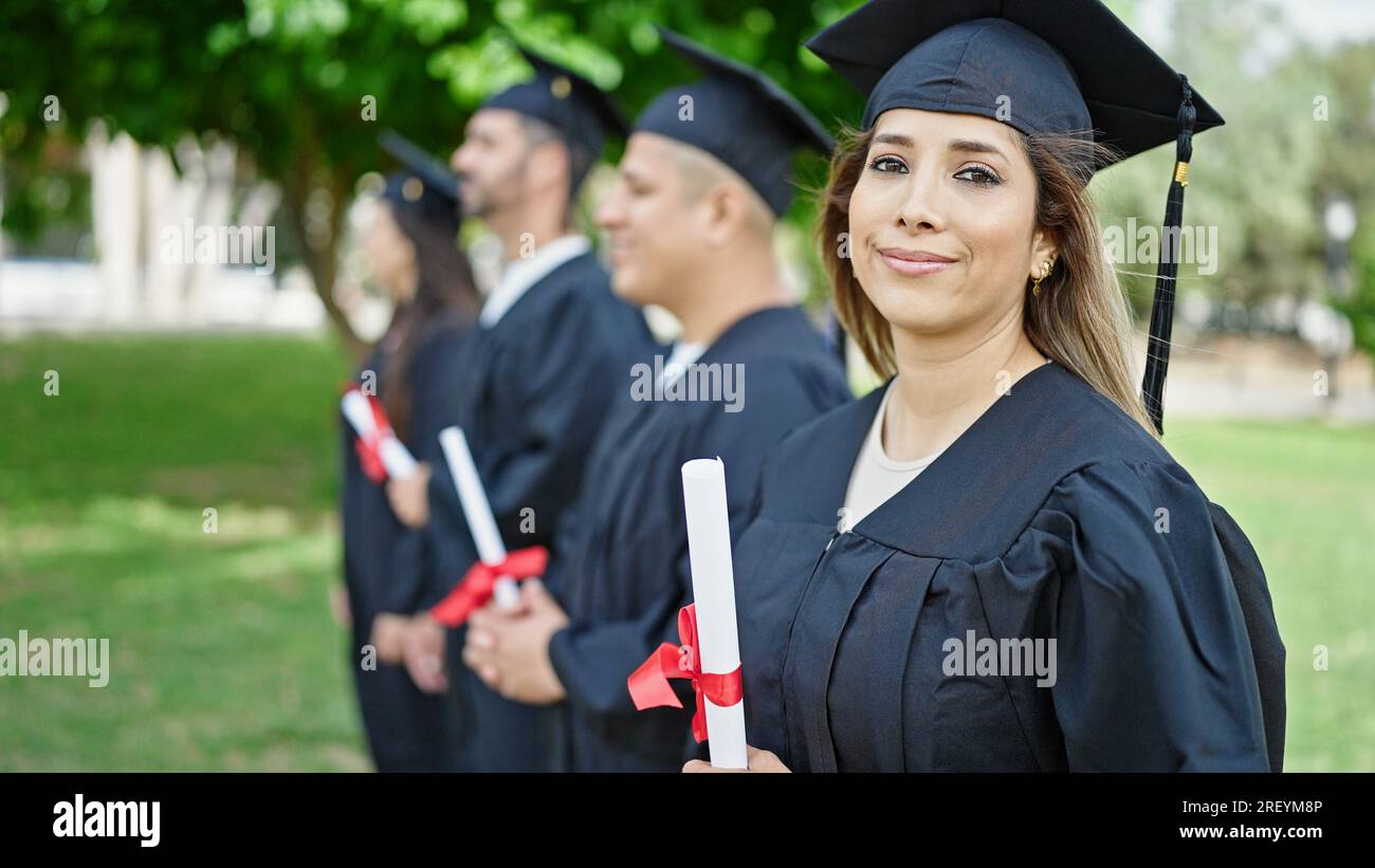 Group of people students graduated holding diploma at university campus ...