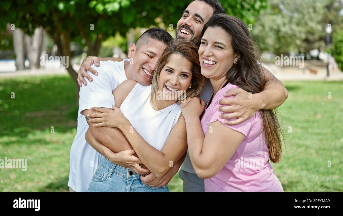 Group of people hugging each other smiling at park Stock Photo - Alamy