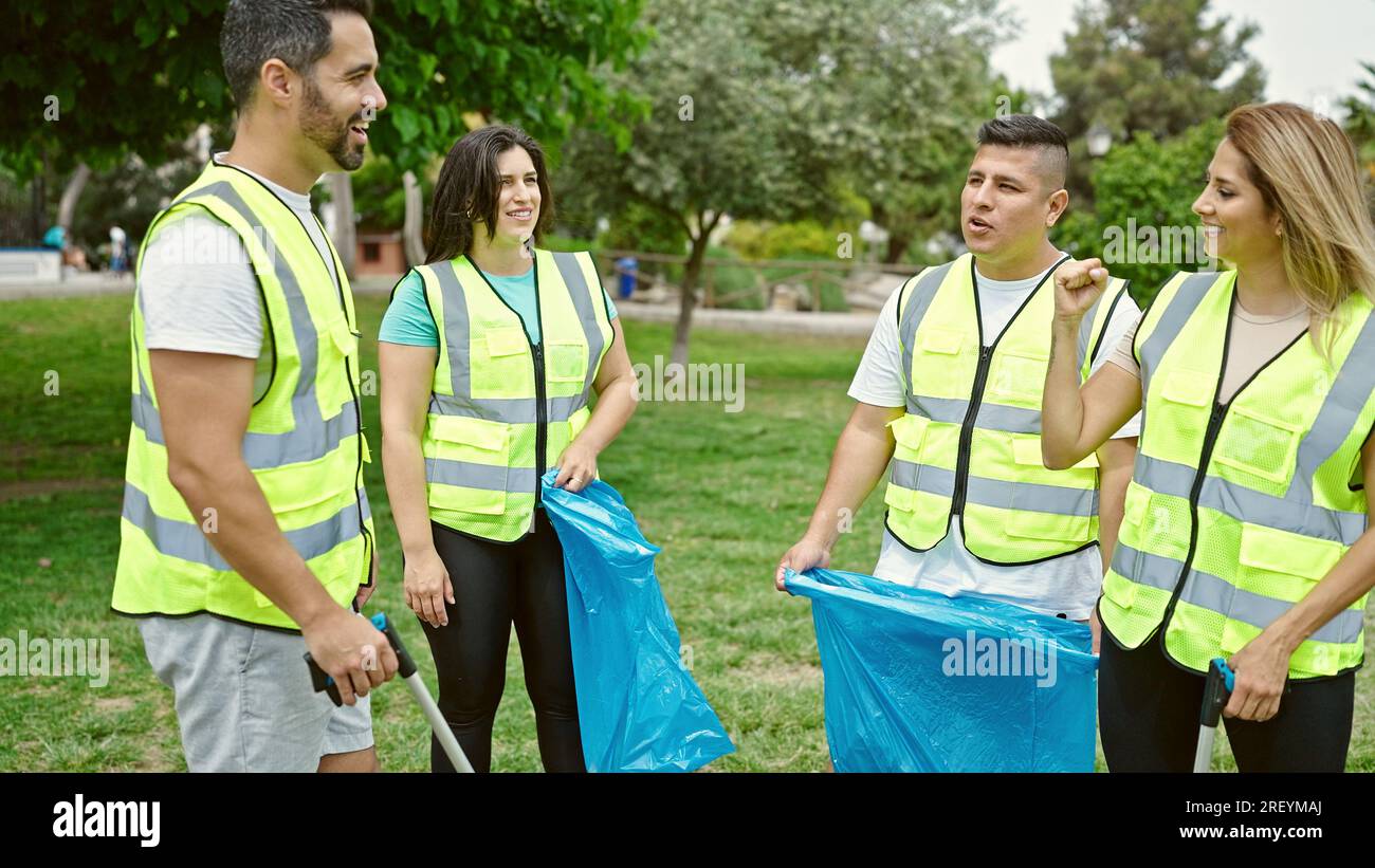 Group of people volunteers speaking to collect trash at park Stock ...