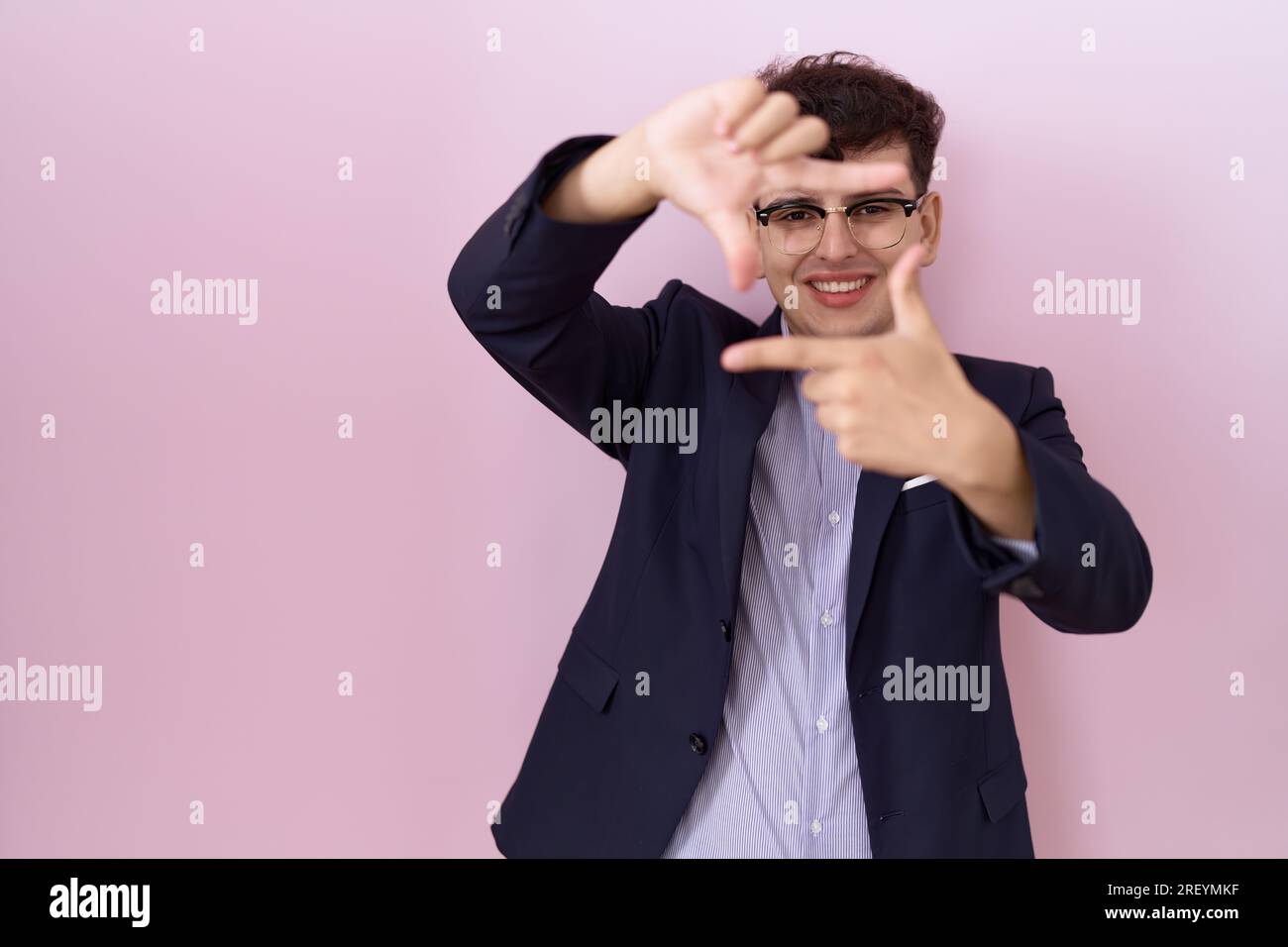 Young non binary man with beard wearing suit and tie smiling making ...