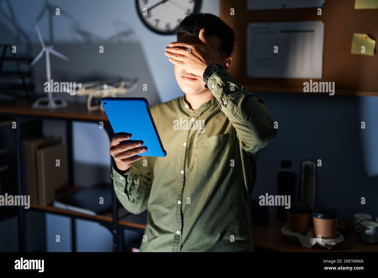 Non binary person using touchpad device at night smiling and laughing ...