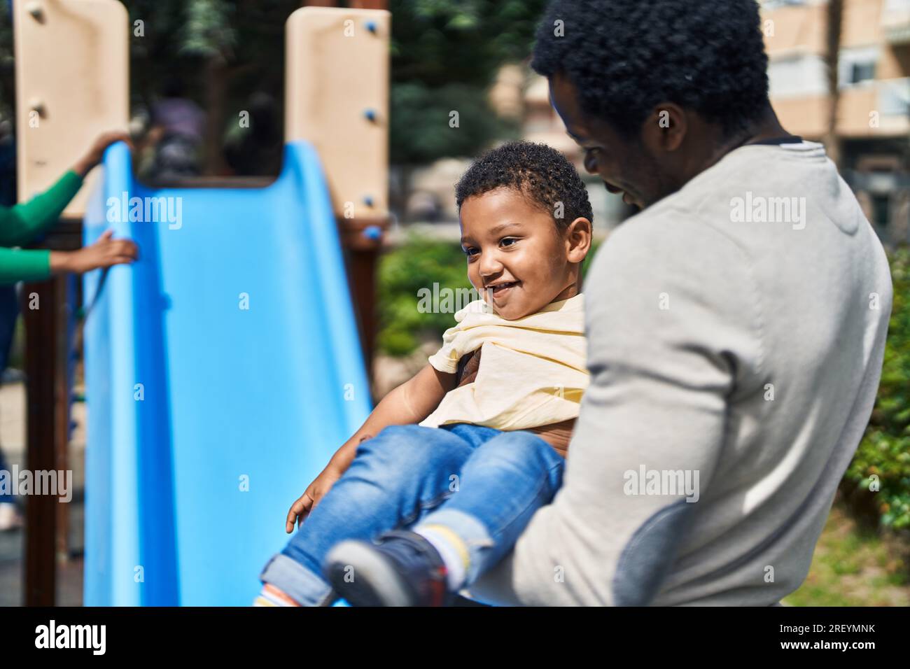 Playground slide man standing hi-res stock photography and images - Alamy