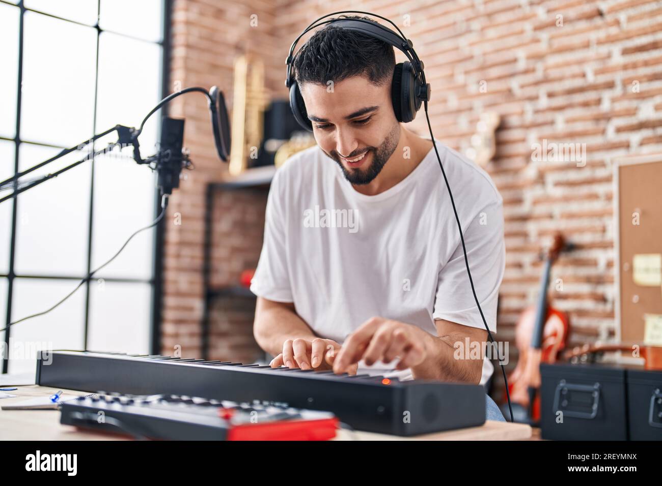 Young arab man musician playing piano keyboard at music studio Stock ...