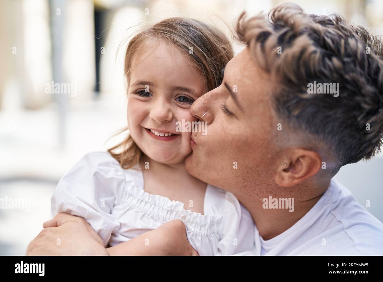 Father and daughter smiling confident hugging each other and kissing at park Stock Photo - Alamy