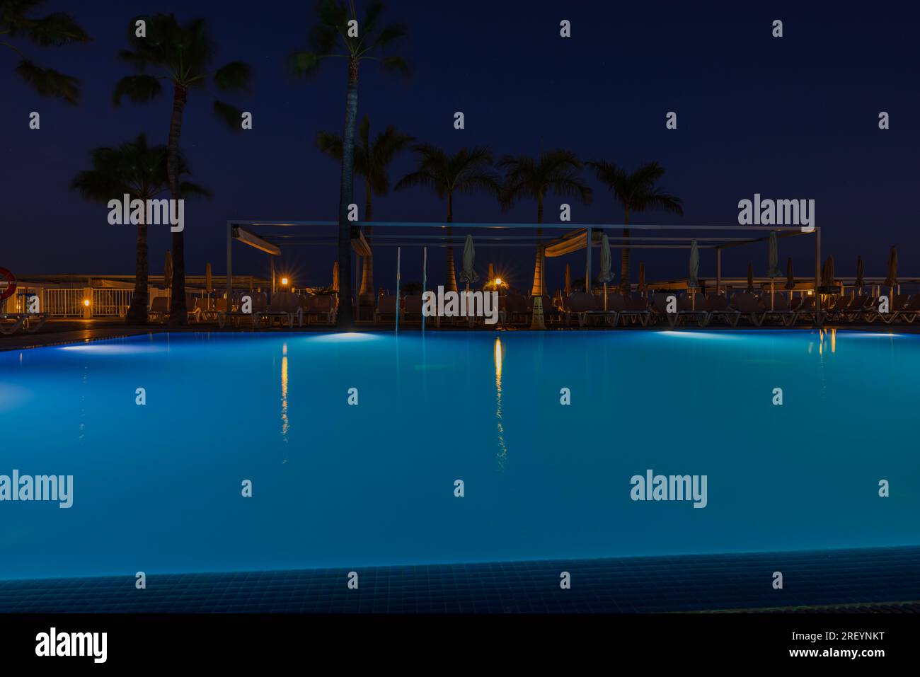 Beautiful night view of hotel with outdoor pool on night sky background ...