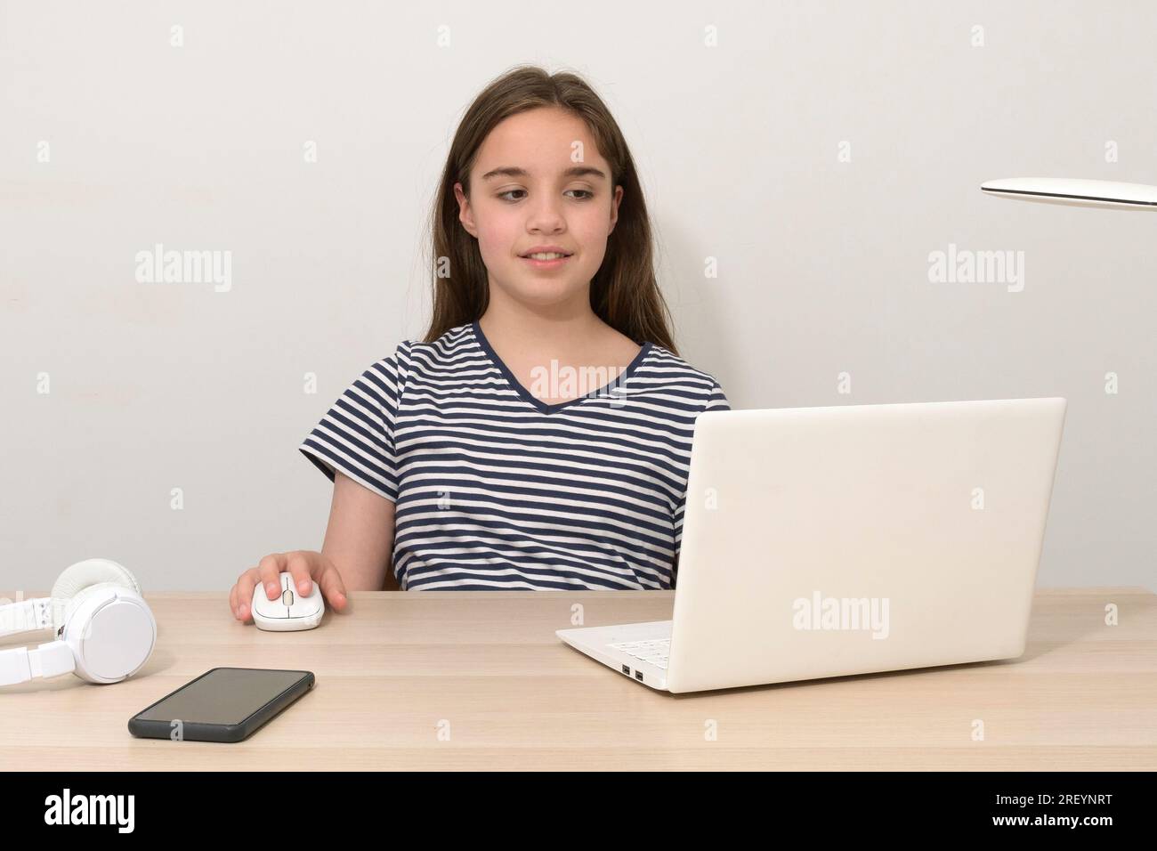 Teenage girl at the table with a computer. lifestyle portrait Stock ...