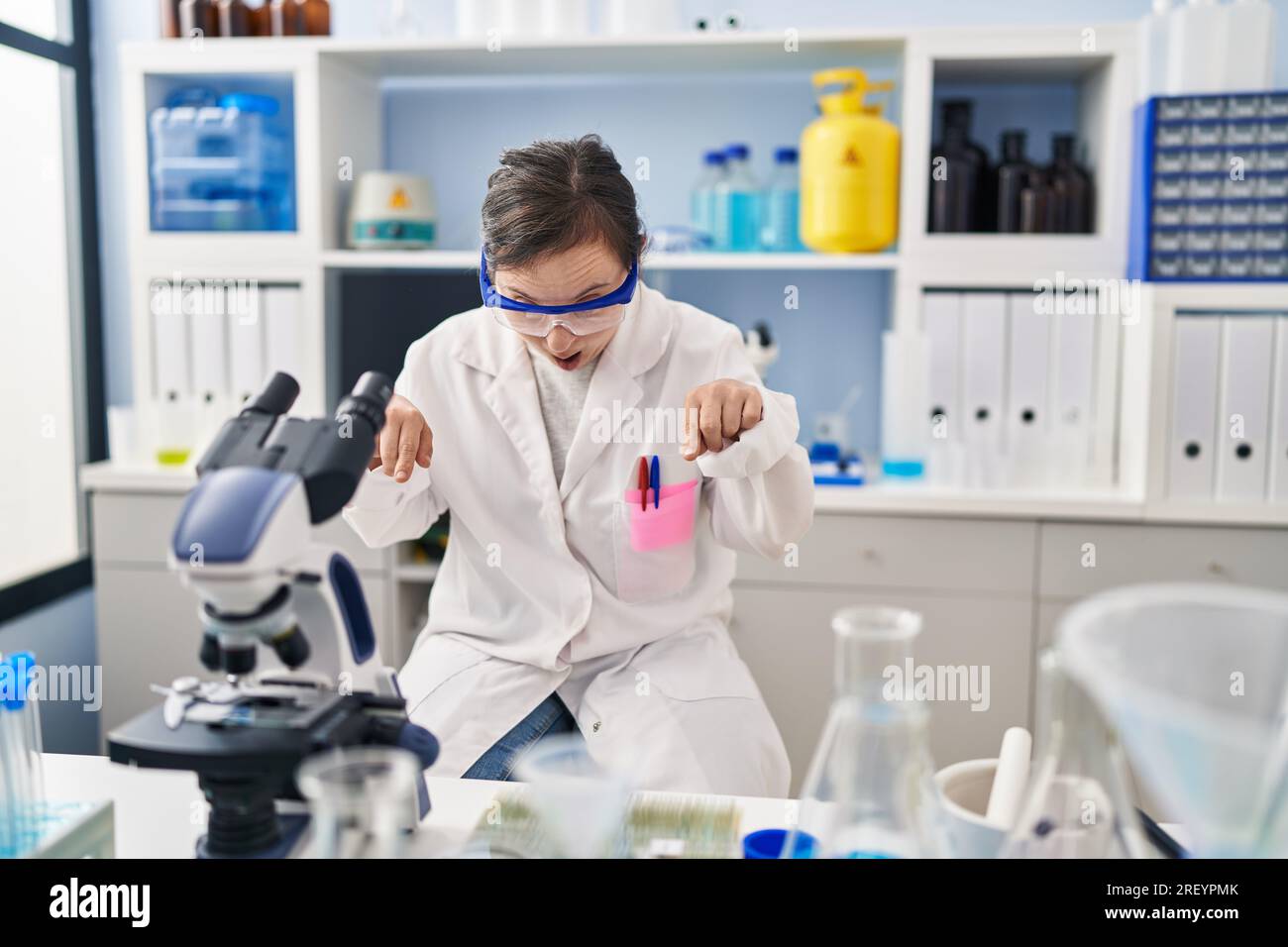 Hispanic girl with down syndrome working at scientist laboratory ...