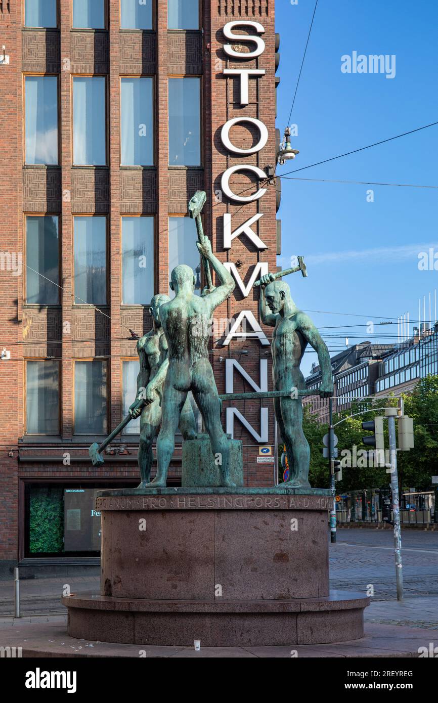 Stockmann department store neon lights and Three Smiths Statue in the ...
