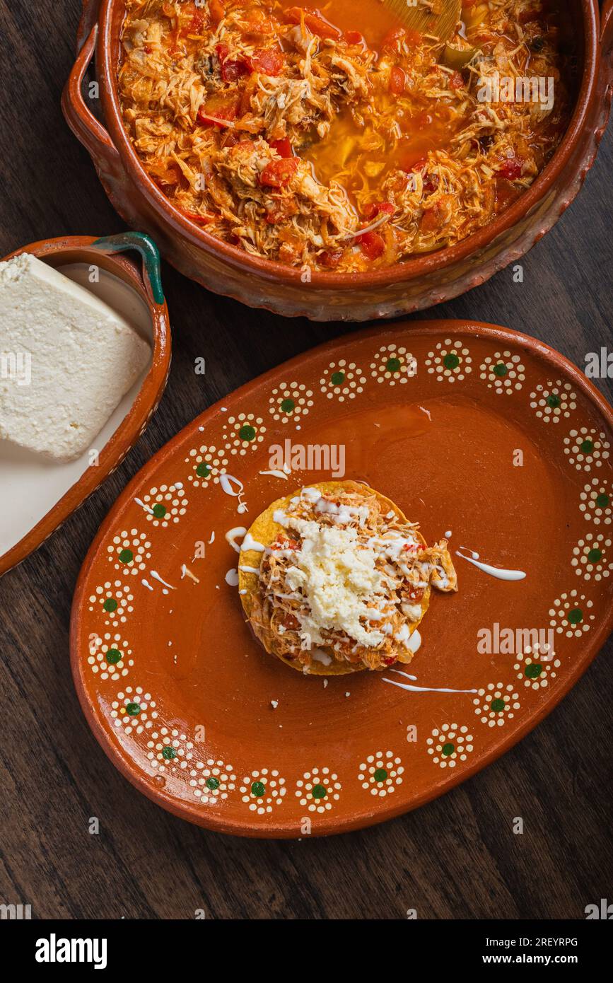 Authentic mexican chicken tinga with fresh cheese and cream on toast ...