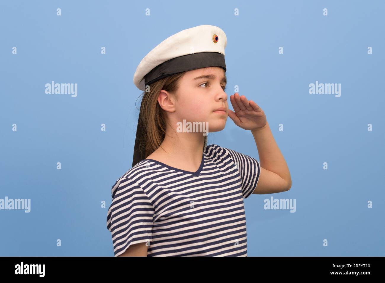 Portrait of a sailor girl on a blue background. Teenage girl in a ...