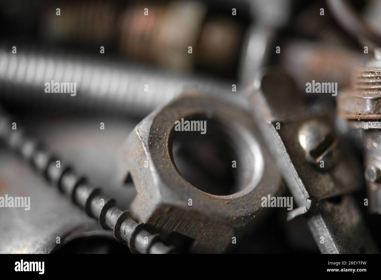 Bolts, cogs and other parts are in a mess in the garage, repair shop ...