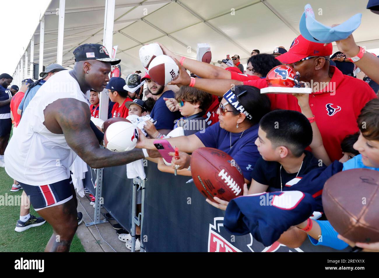 Houston Texans offensive tackle Laremy Tunsil, left, gives autographs ...