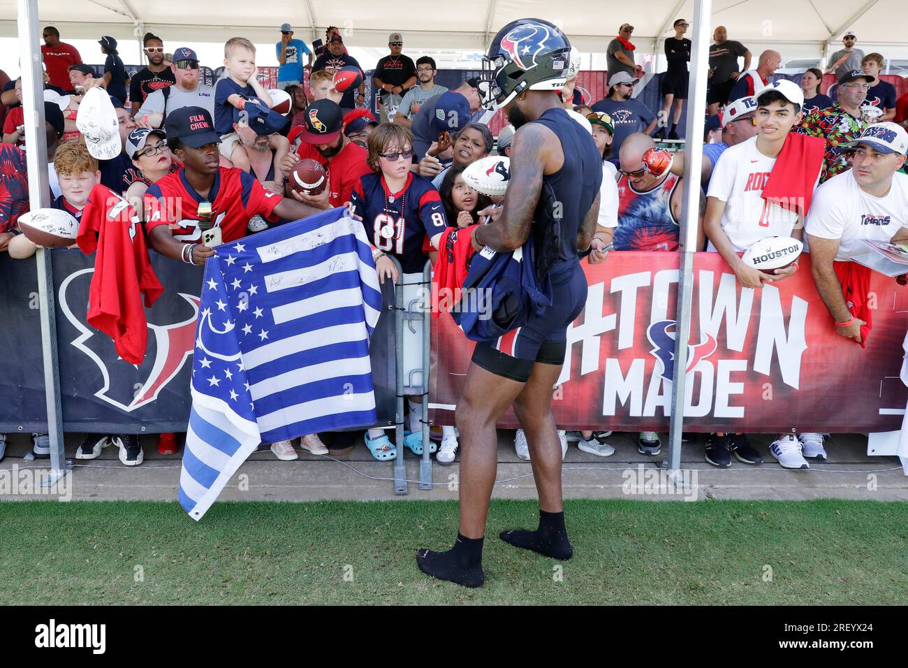 Houston Texans wide receiver Nico Collins, front, gives autographs ...