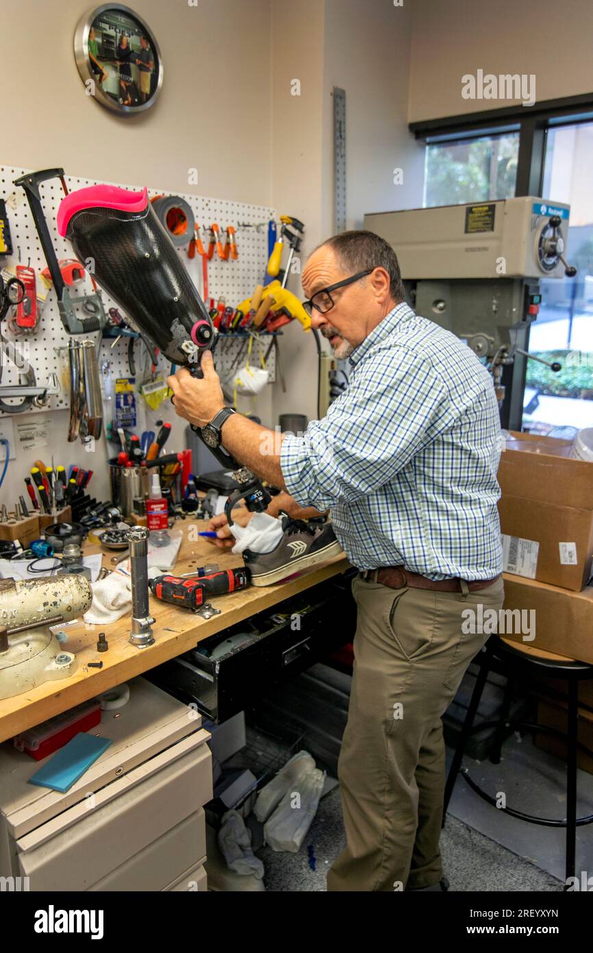 A technician works on a a prosthetic leg in the workshop of a ...