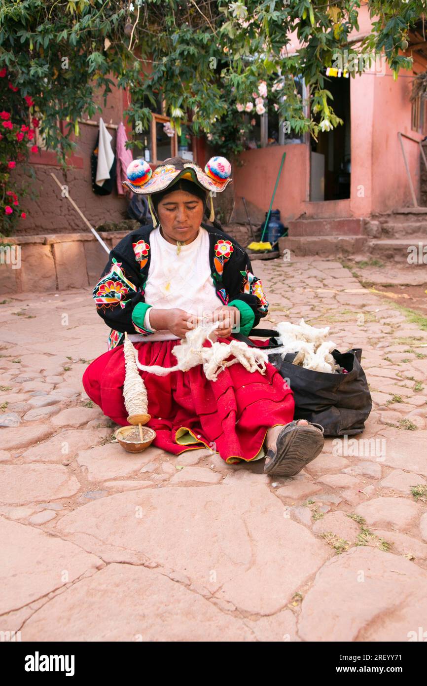 Llachon, Peru; 1st January 2023: A woman working with wool on the ...