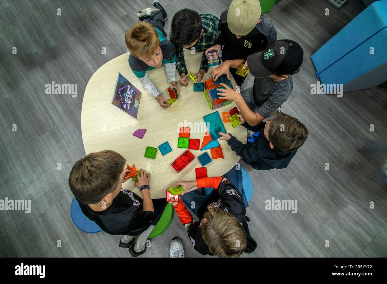 Boys assemble plastic magnets at a creative "Innovation Lab" at a ...