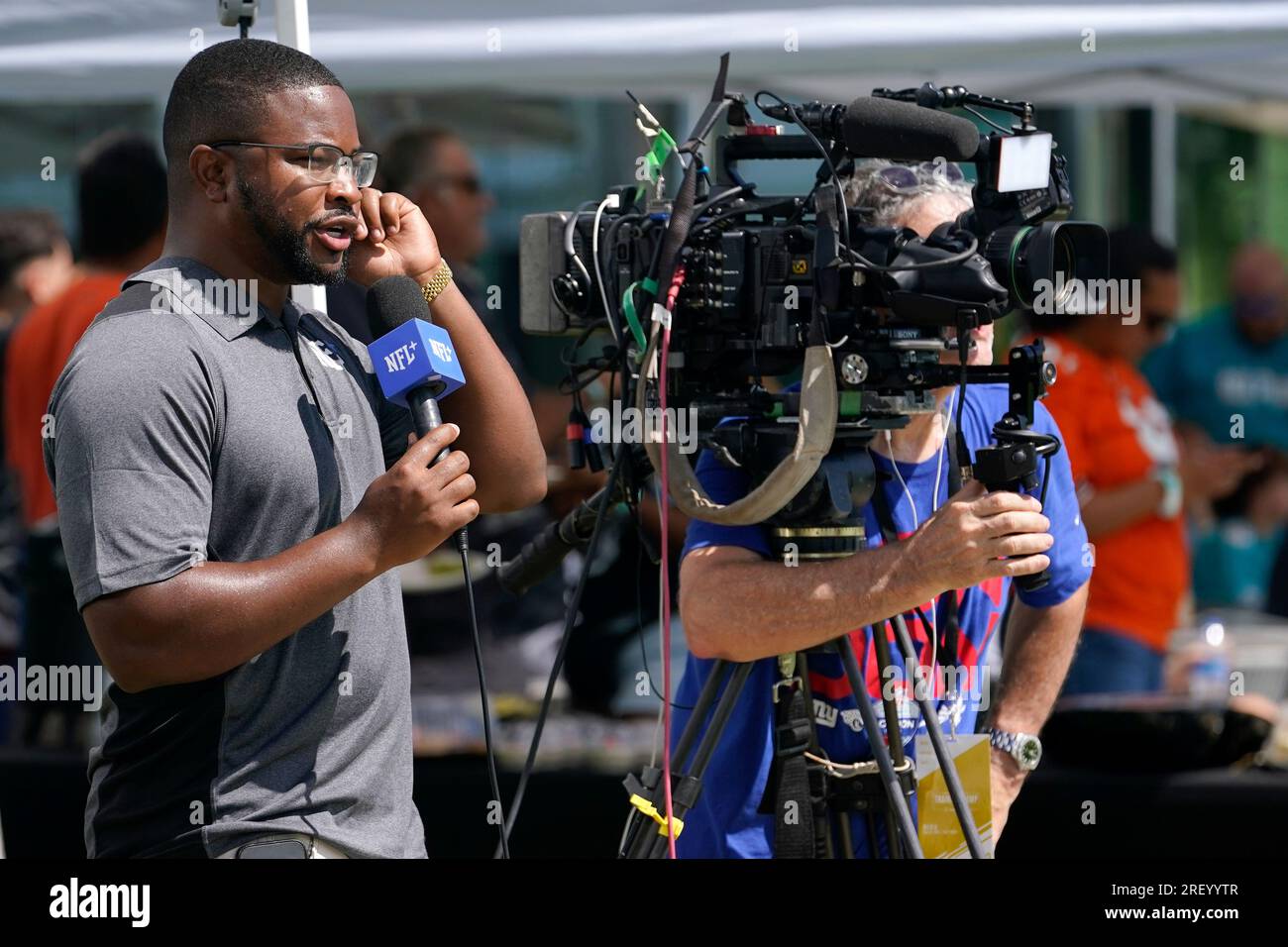 NFL Network reporter Cameron Wolfe, left, broadcasts from a Miami ...
