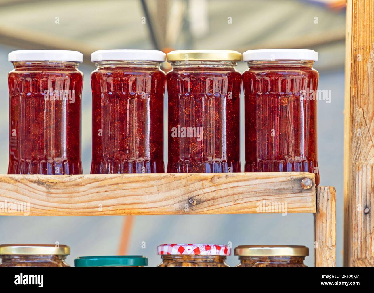 Homemade strawberry jam in glass jars on shelf sold on market Stock ...