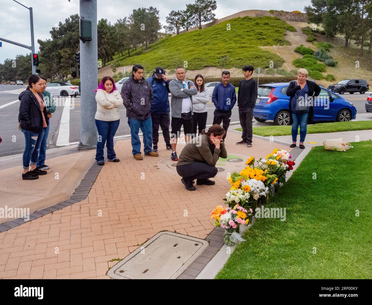 Multiracial friends and family of a traffic accident victim gather for ...