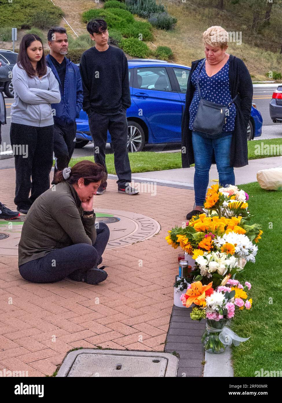 Multiracial friends and family of a traffic accident victim gather for ...