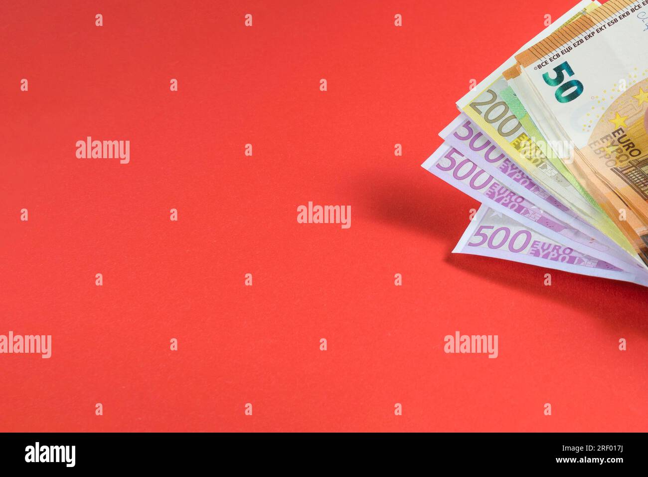 Euro banknotes on a red background. different denomination. Located in ...