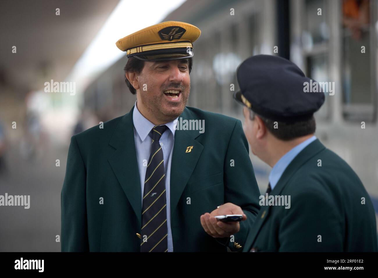 Trenitalia platform staff helping passengers at Milan's busy mainline ...