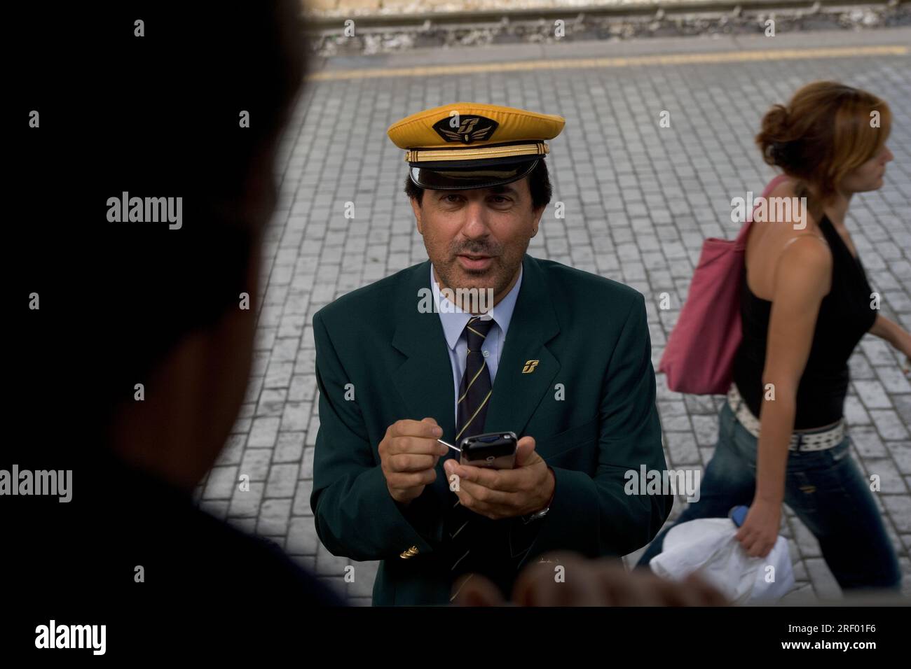 Trenitalia platform staff helping passengers at Milan's busy mainline ...