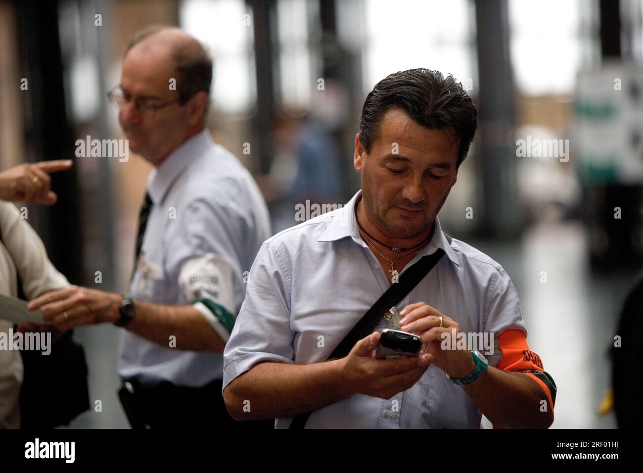 Trenitalia platform staff helping passengers at Milan's busy mainline ...