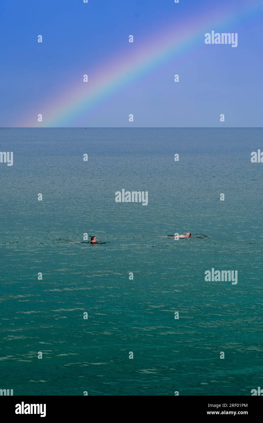 An organised wild water swimming adventure activity in calm turquoise ...